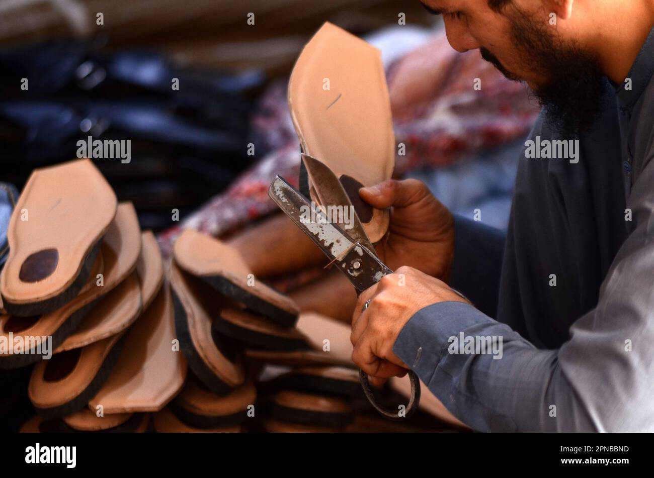 A Pakistani cobbler makes traditional Peshawari Chappal shoes ahead of ...