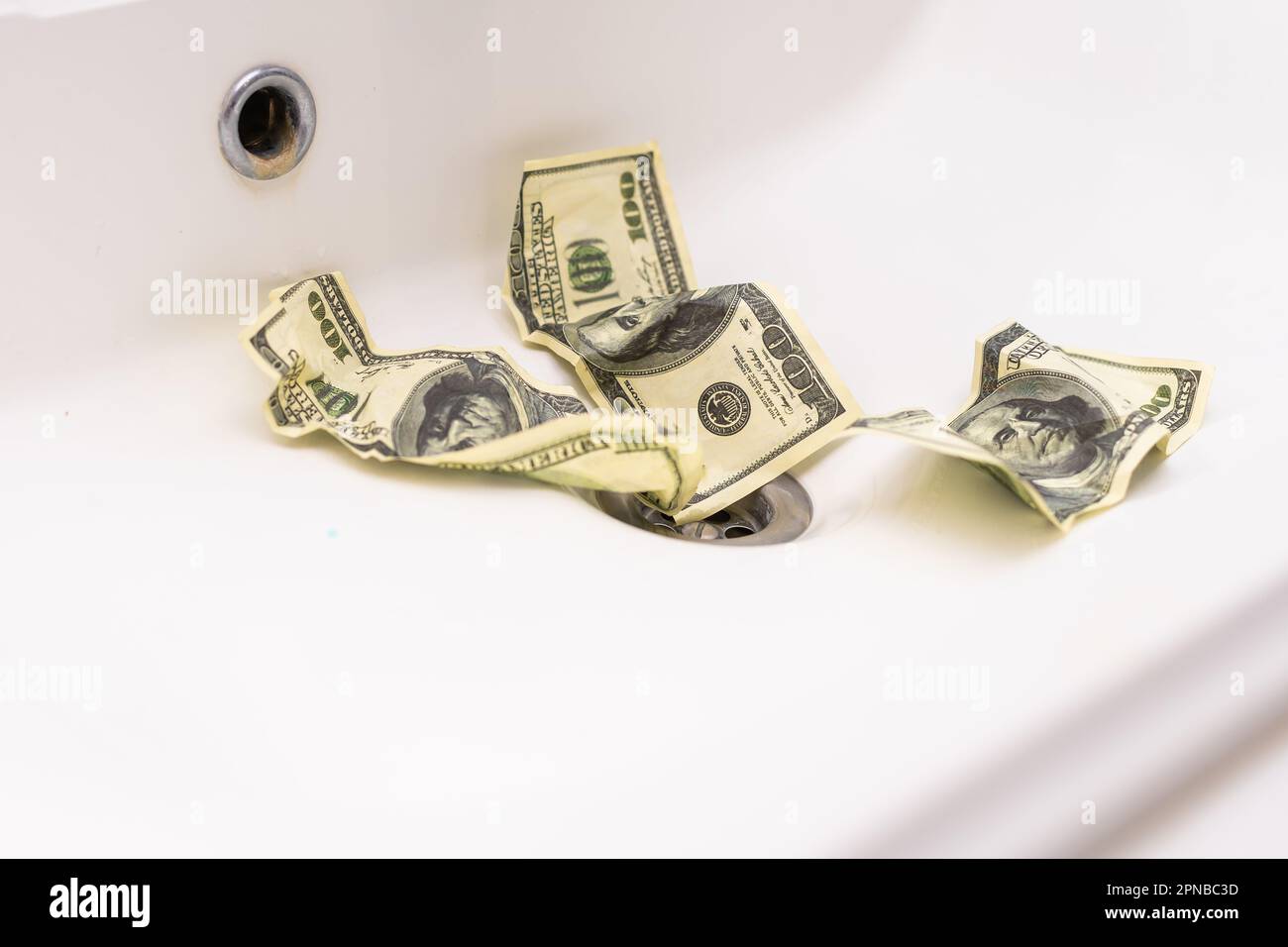 Money down the drain metaphor hi-res stock photography and images - Alamy