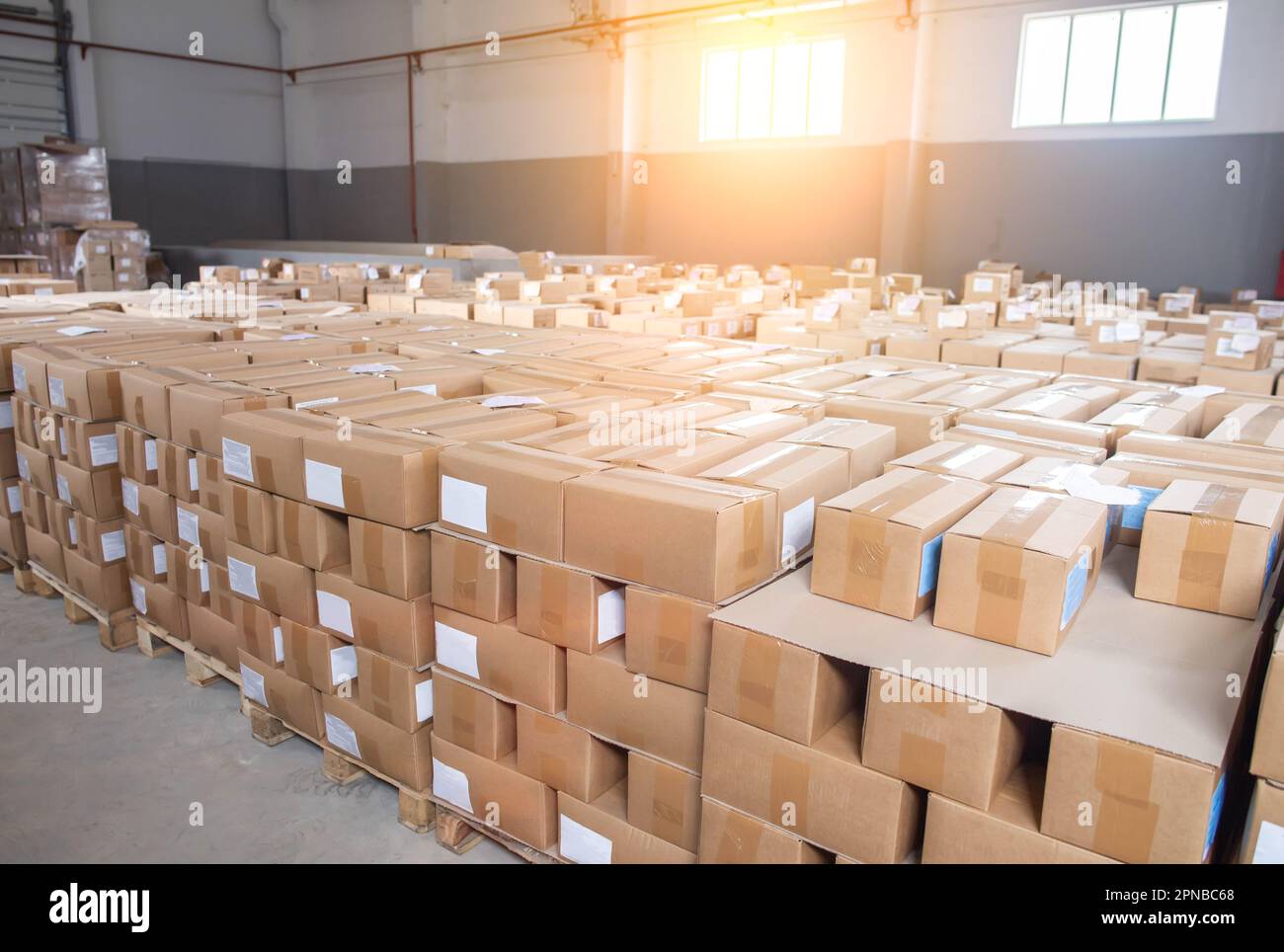 A lot of cardboard boxes with finished products with sweets stand in a ...