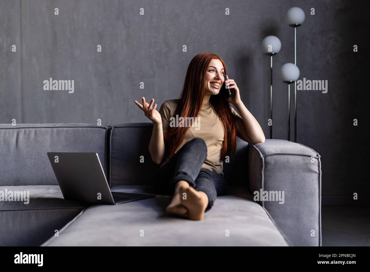Phone conversation. Confident young woman sit on couch talk speak ...