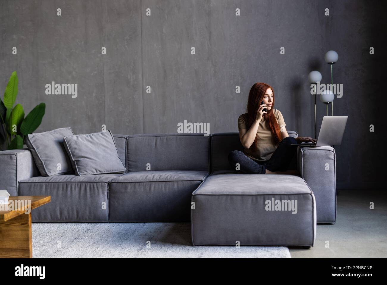 Phone conversation. Confident young woman sit on couch talk speak ...