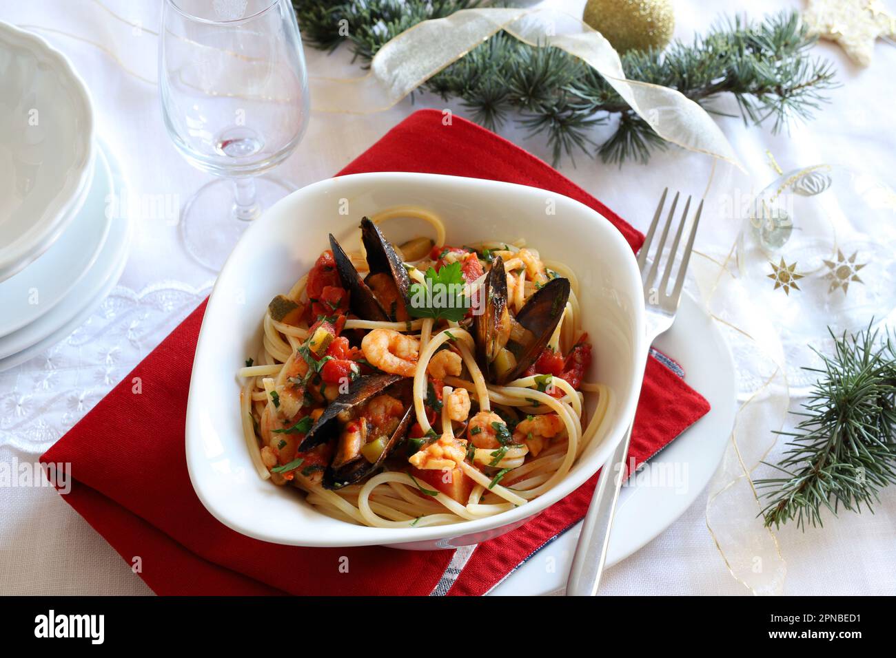 Spaghetti with seafood. Christmas festive table setting for the festive ...