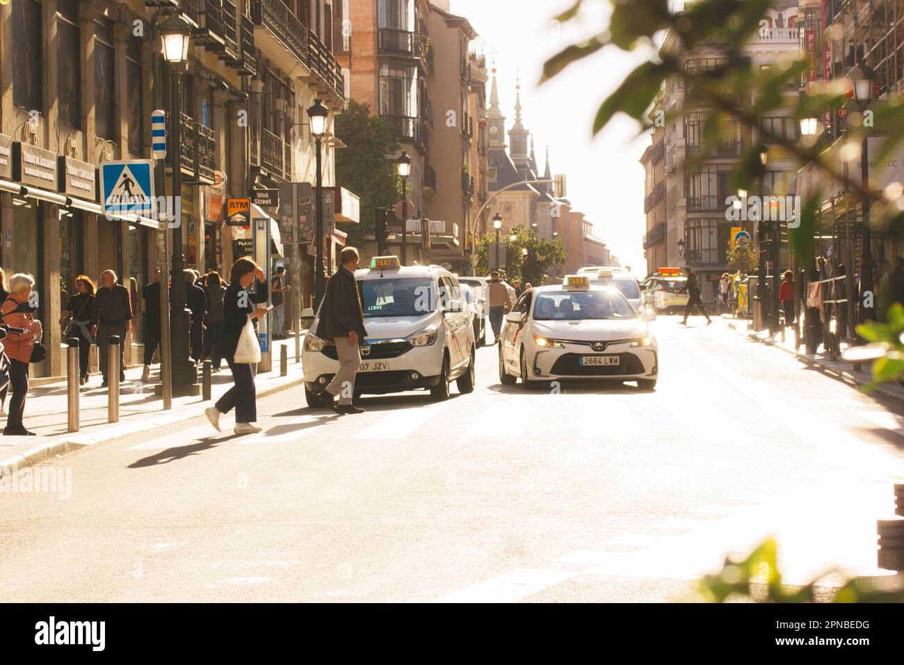 Madrid, Spain. July 1, 2022 A white cab service car on city street ...