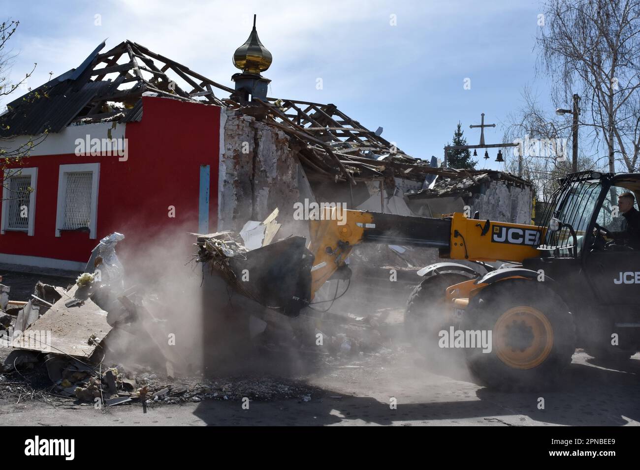 Worker clear the rubble and debris with the excavator after a Russian ...