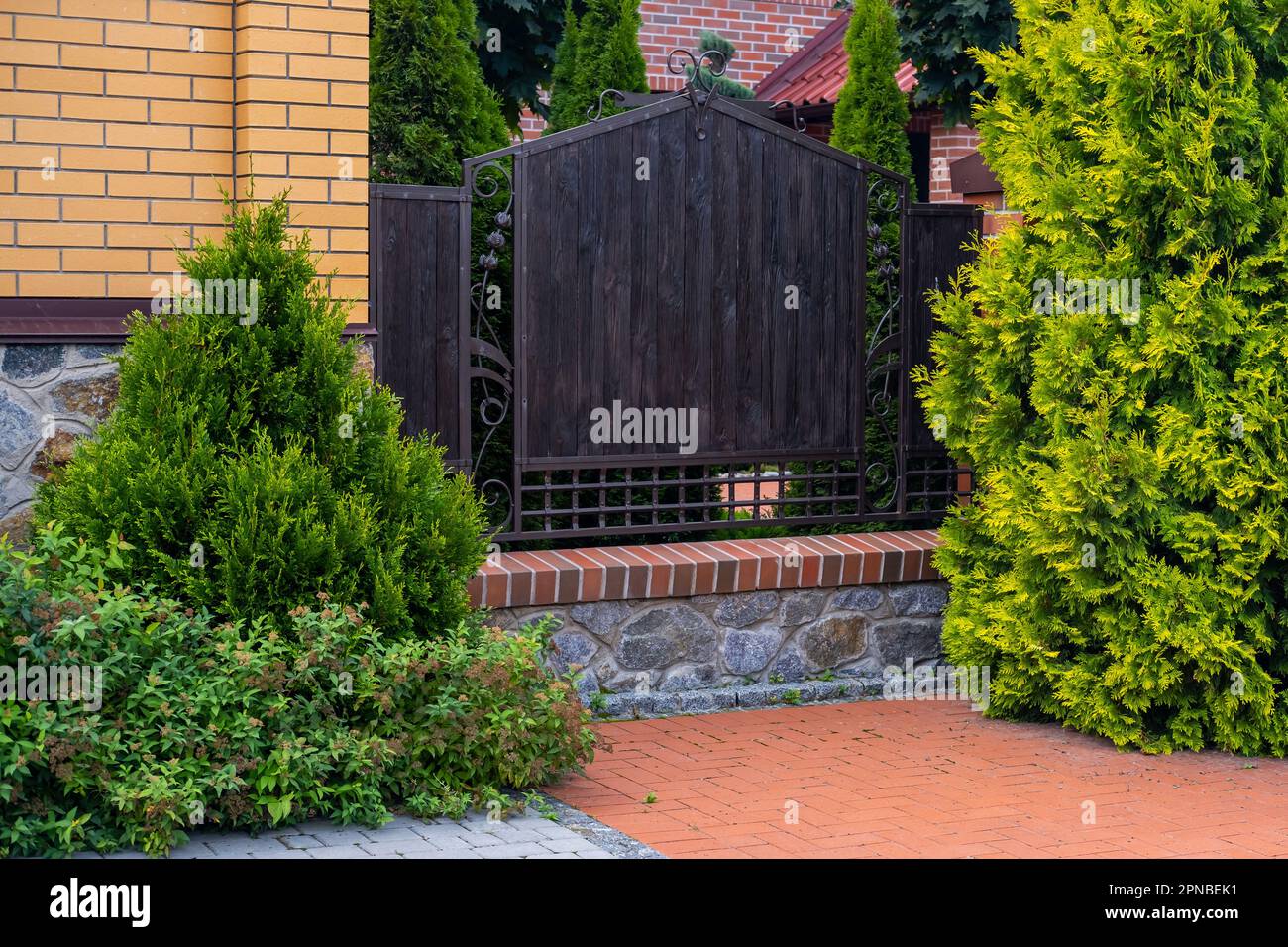 Beautiful decorative modern wooden fence with brick columns Stock Photo ...