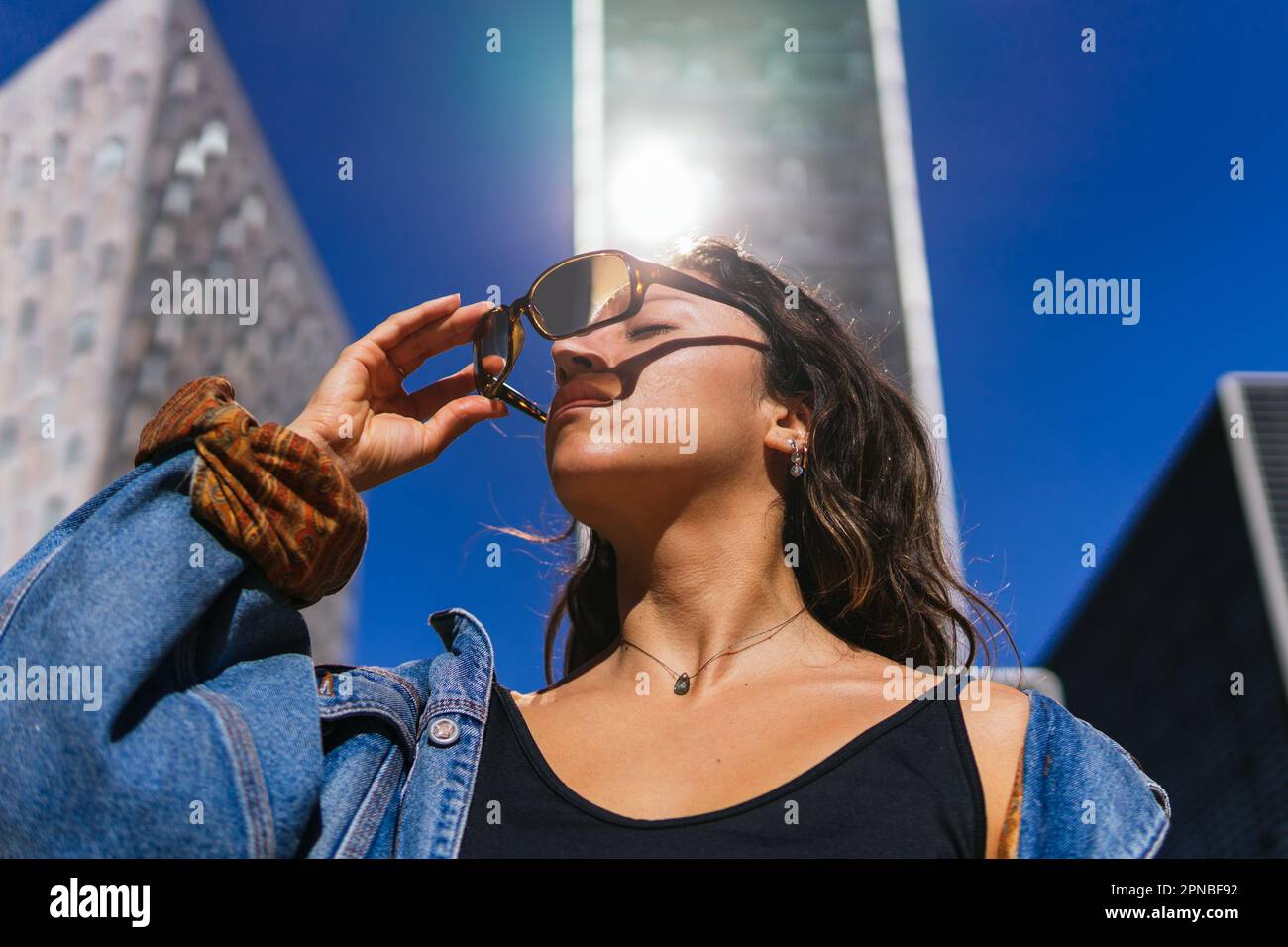 Woman taking off jacket hi-res stock photography and images - Alamy