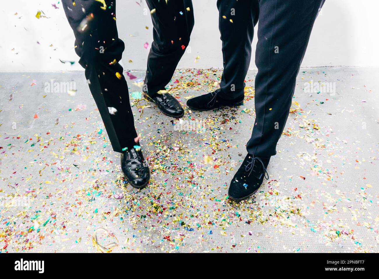 From above of crop anonymous male partners in formal trousers and shoes ...