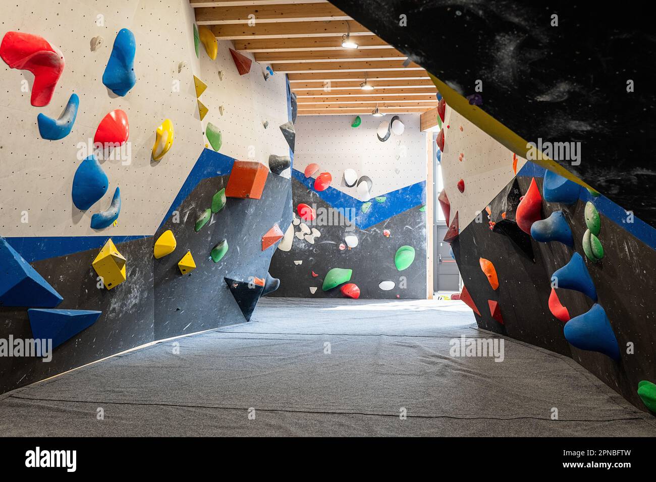 Contemporary indoors climbing gym decorated with polyethylene foams and ...