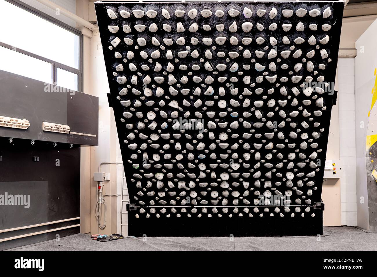 Kilter boards in square shape placed in gym supporting adjustable or ...