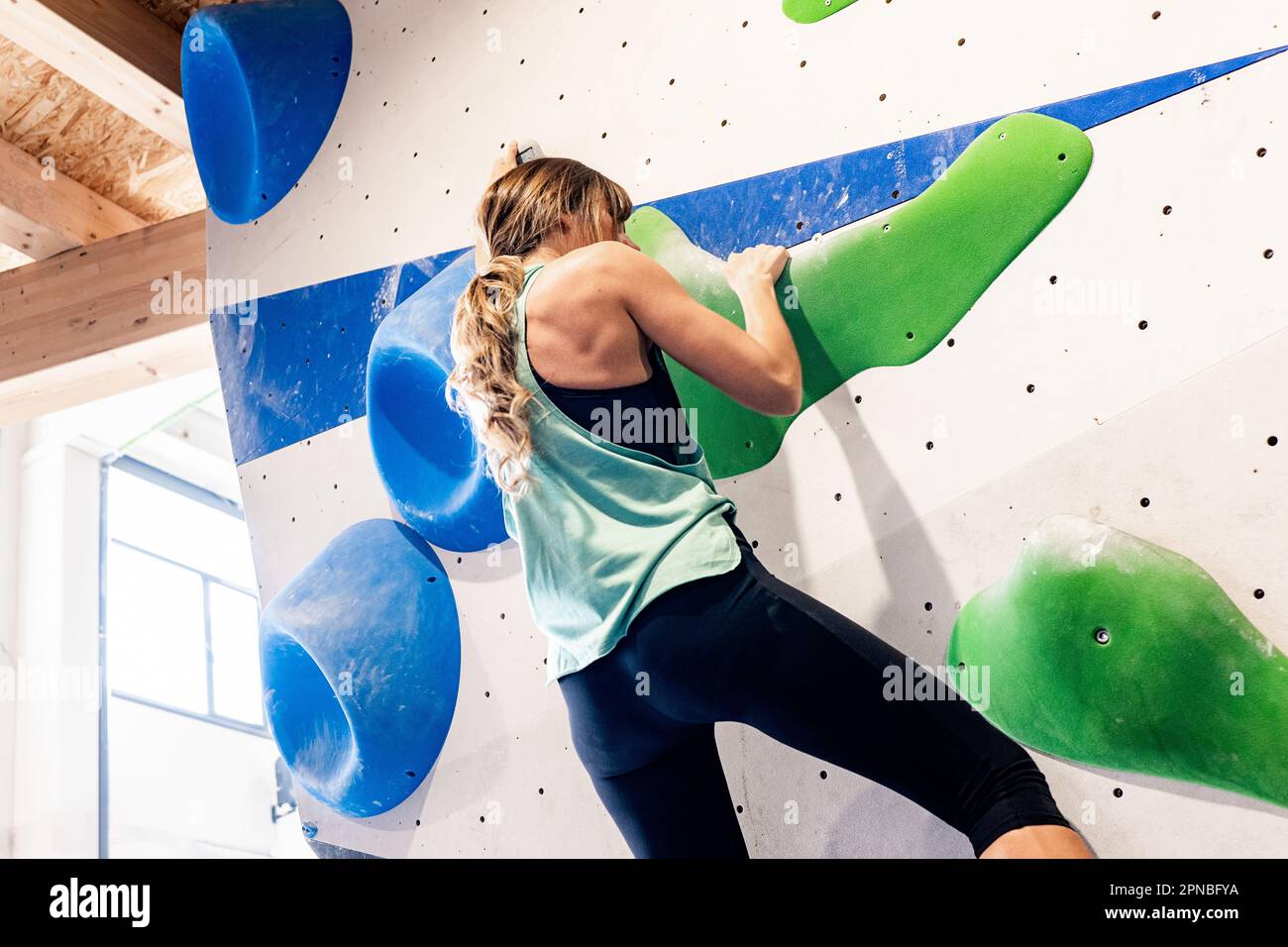 From below back view of anonymous female athlete in sportswear and ...