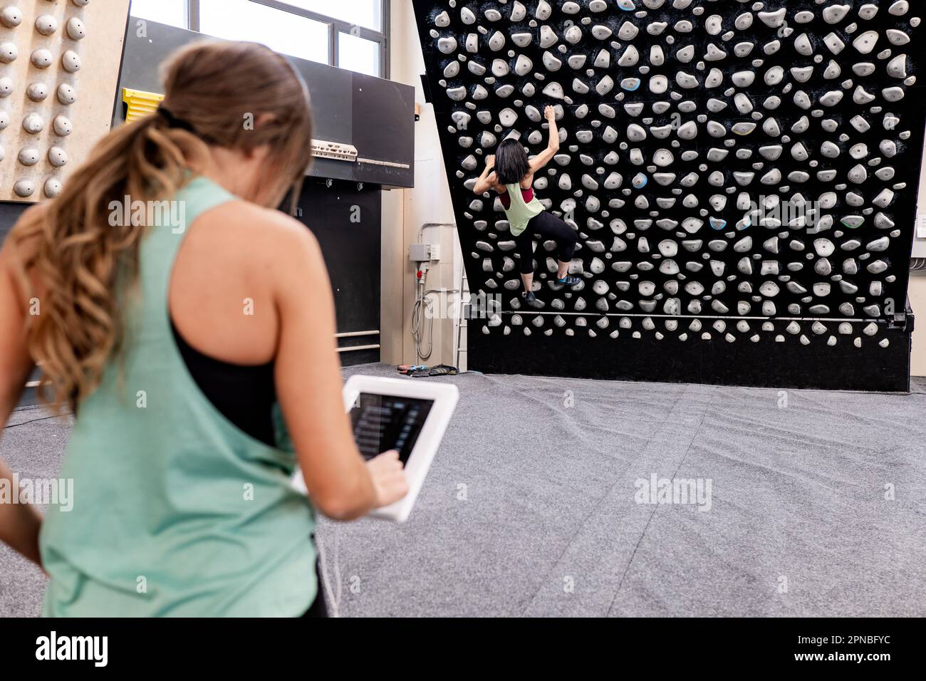 Back view of anonymous female standing and making changes of angle ...