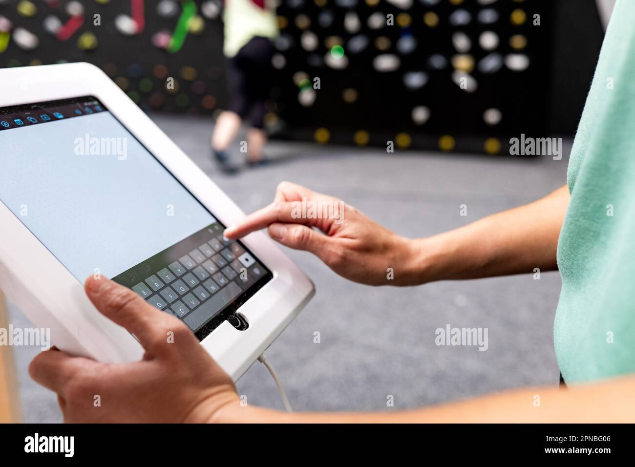 From above of anonymous person using tablet with keyboard and making ...