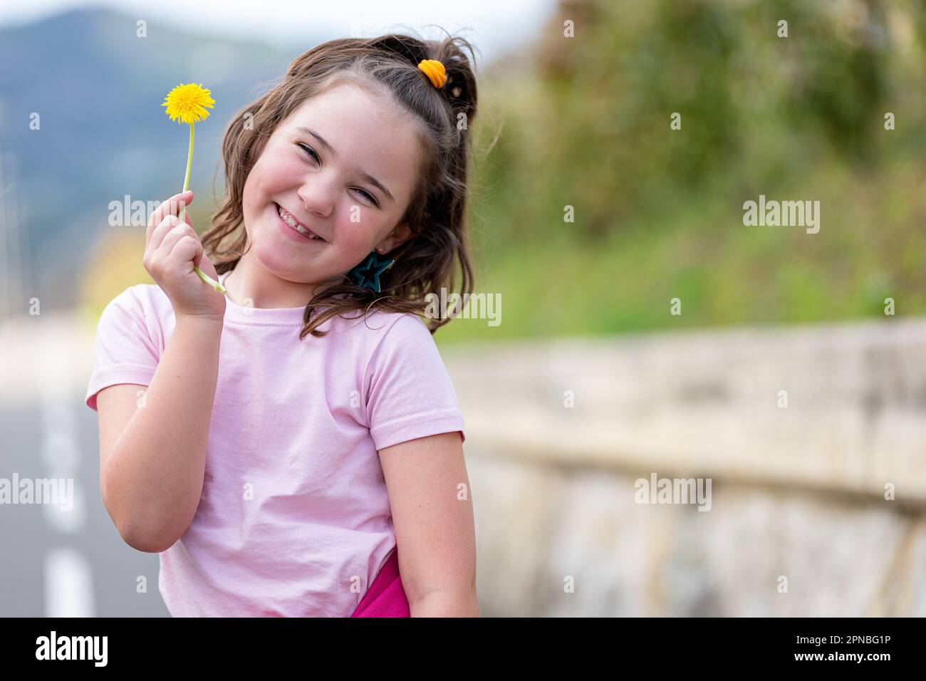 Cute little girl kid smiling with tilted head and looking at camera ...