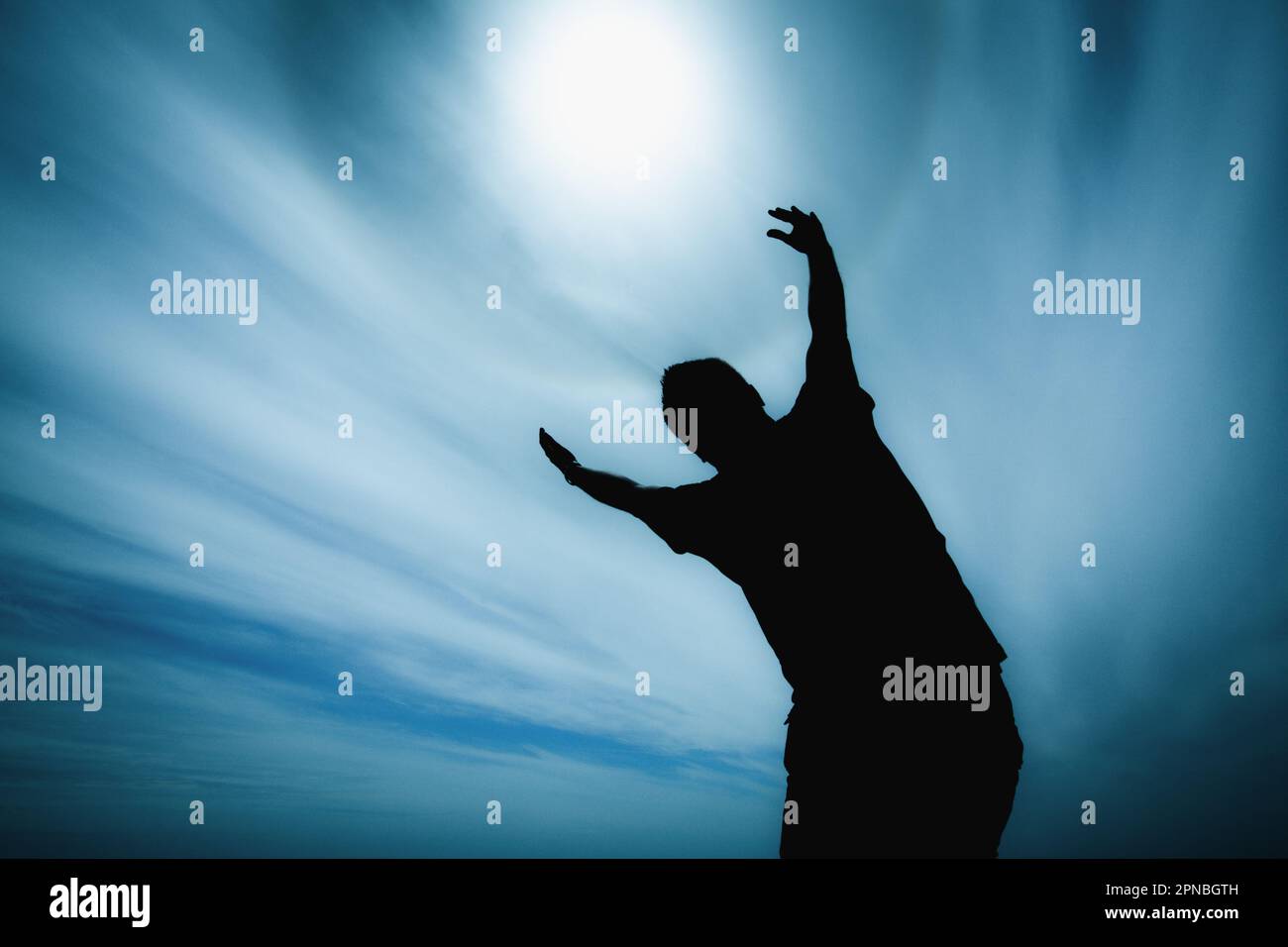 Silhouette of man with outstretched hands Stock Photo - Alamy