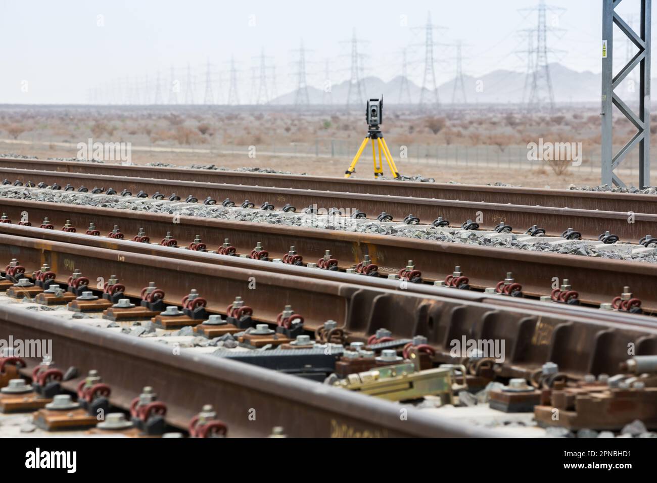 Railroad station with metal rails located near power lines in ...
