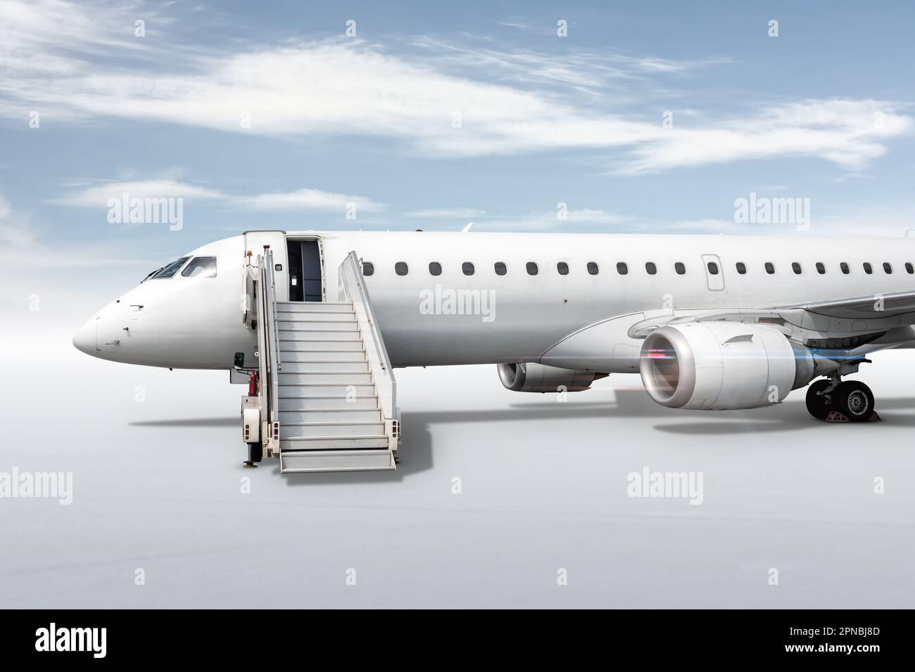 White passenger jet plane with boarding stairs isolated on bright ...