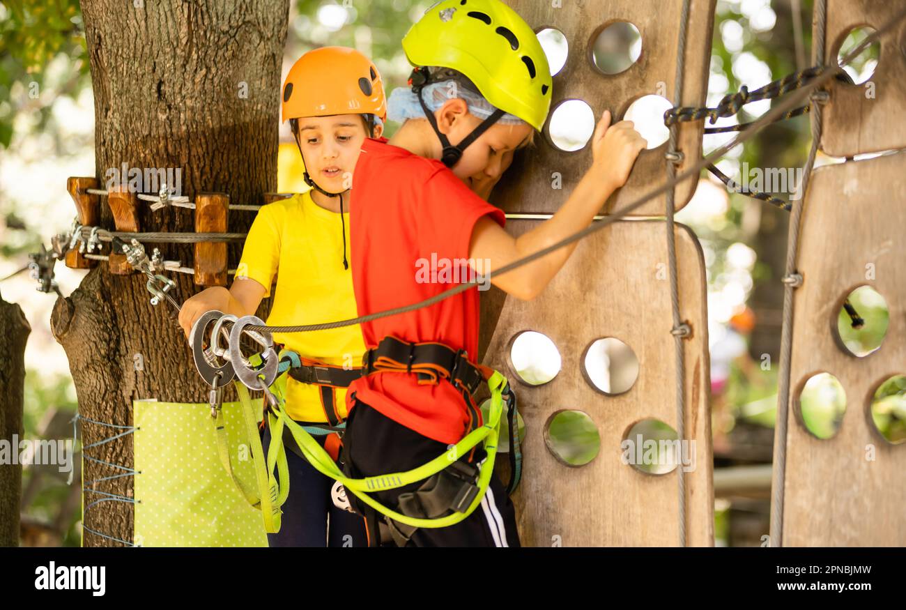 Happy child climbing in the trees. Rope park. Climber child. Early ...