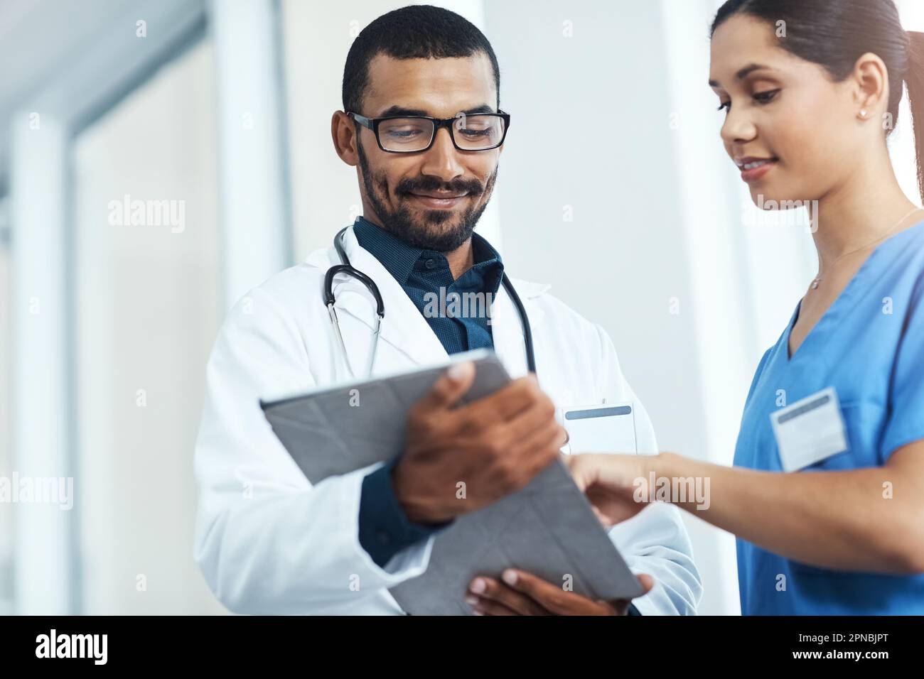 Successful doctors value the importance of teamwork. two young doctors ...