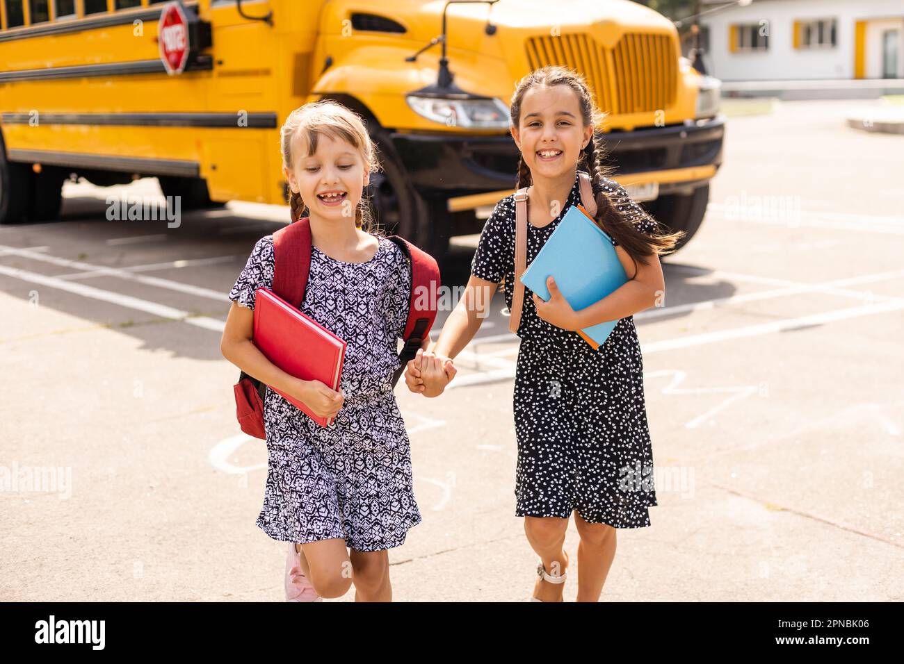 Education: Smiling Student Friends Ready For School next to school bus ...