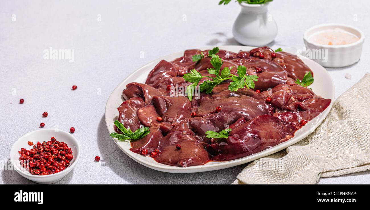 Raw chicken liver on stone background. Fresh ingredients ready for ...