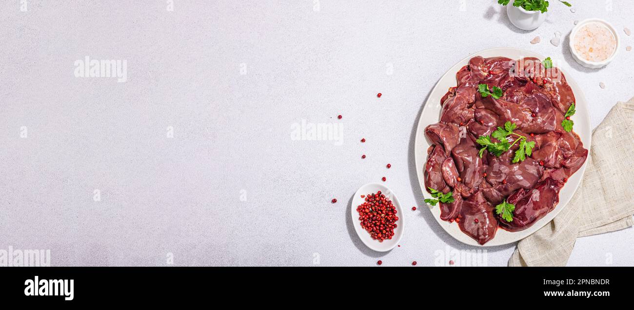 Raw chicken liver on stone background. Fresh ingredients ready for ...