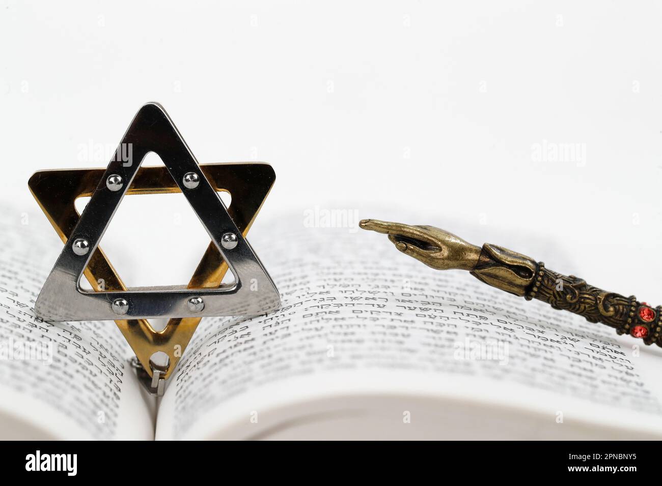 Close-up detail of a Torah in hebrew, a star of David and a yad. Jewish ...