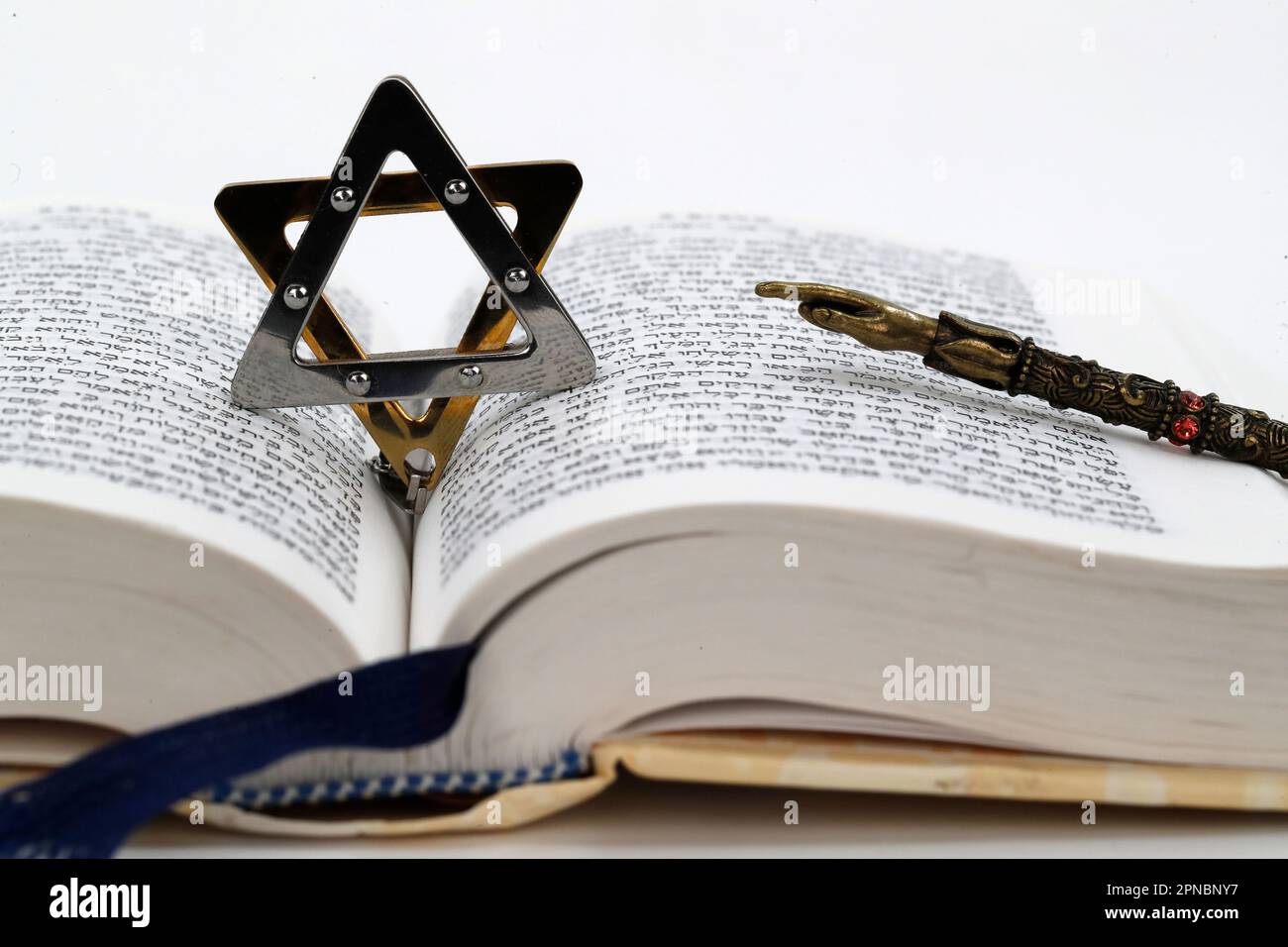 Close-up detail of a Torah in hebrew, a star of David and a yad. Jewish ...
