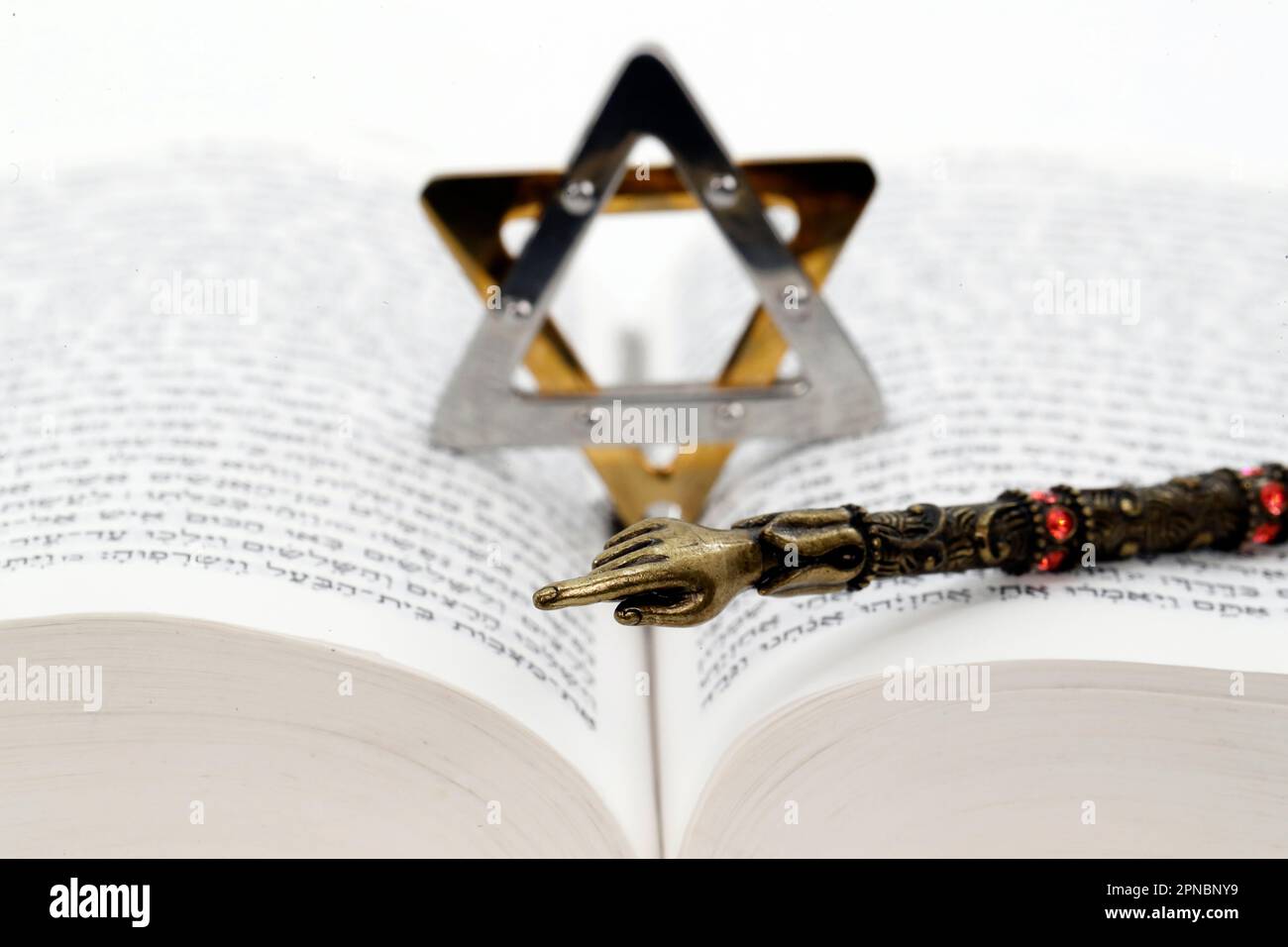 Close-up detail of a Torah in hebrew, a star of David and a yad. Jewish ...