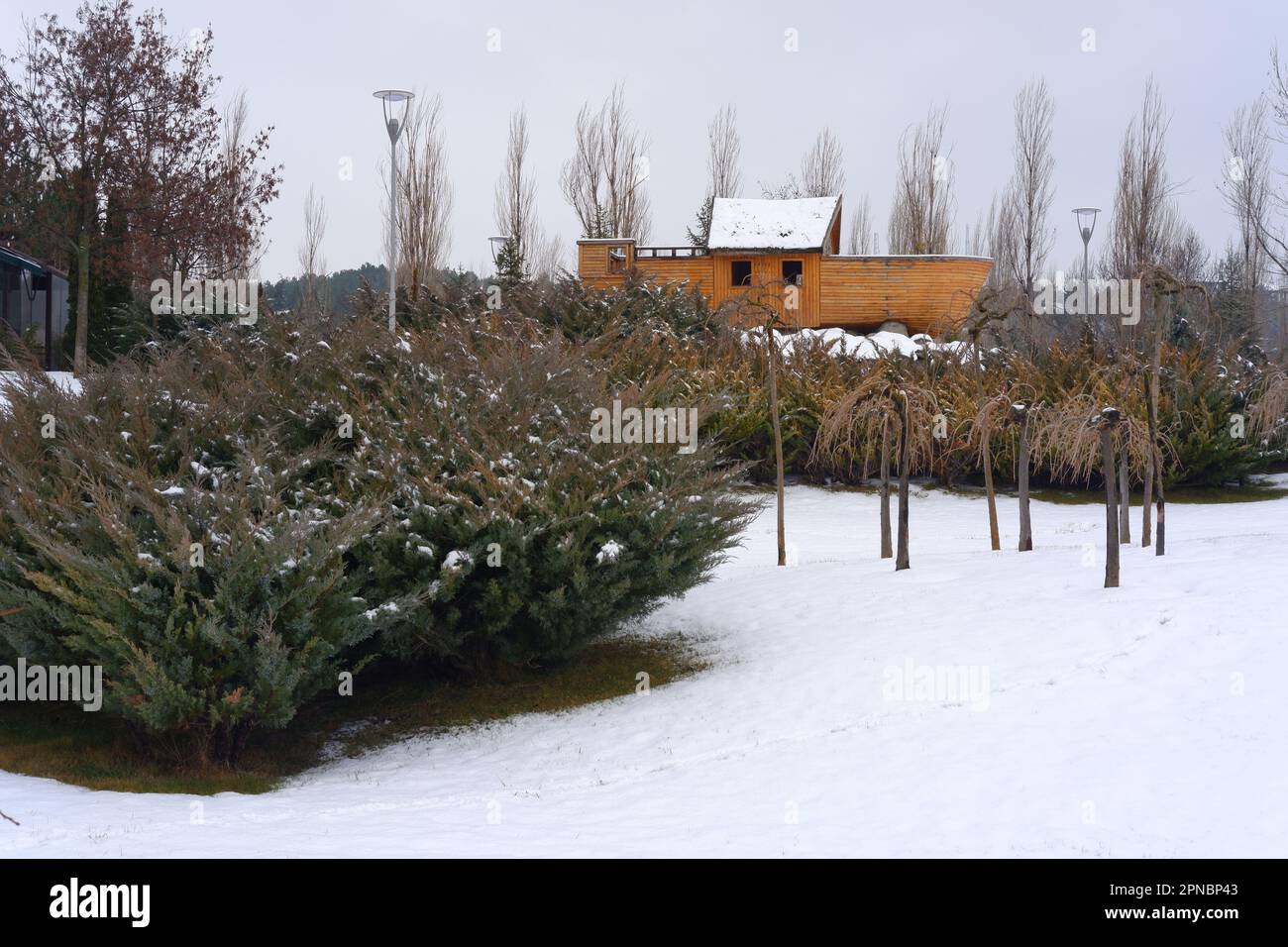 Smaal wooden boat under snow between bushes and trees Stock Photo - Alamy