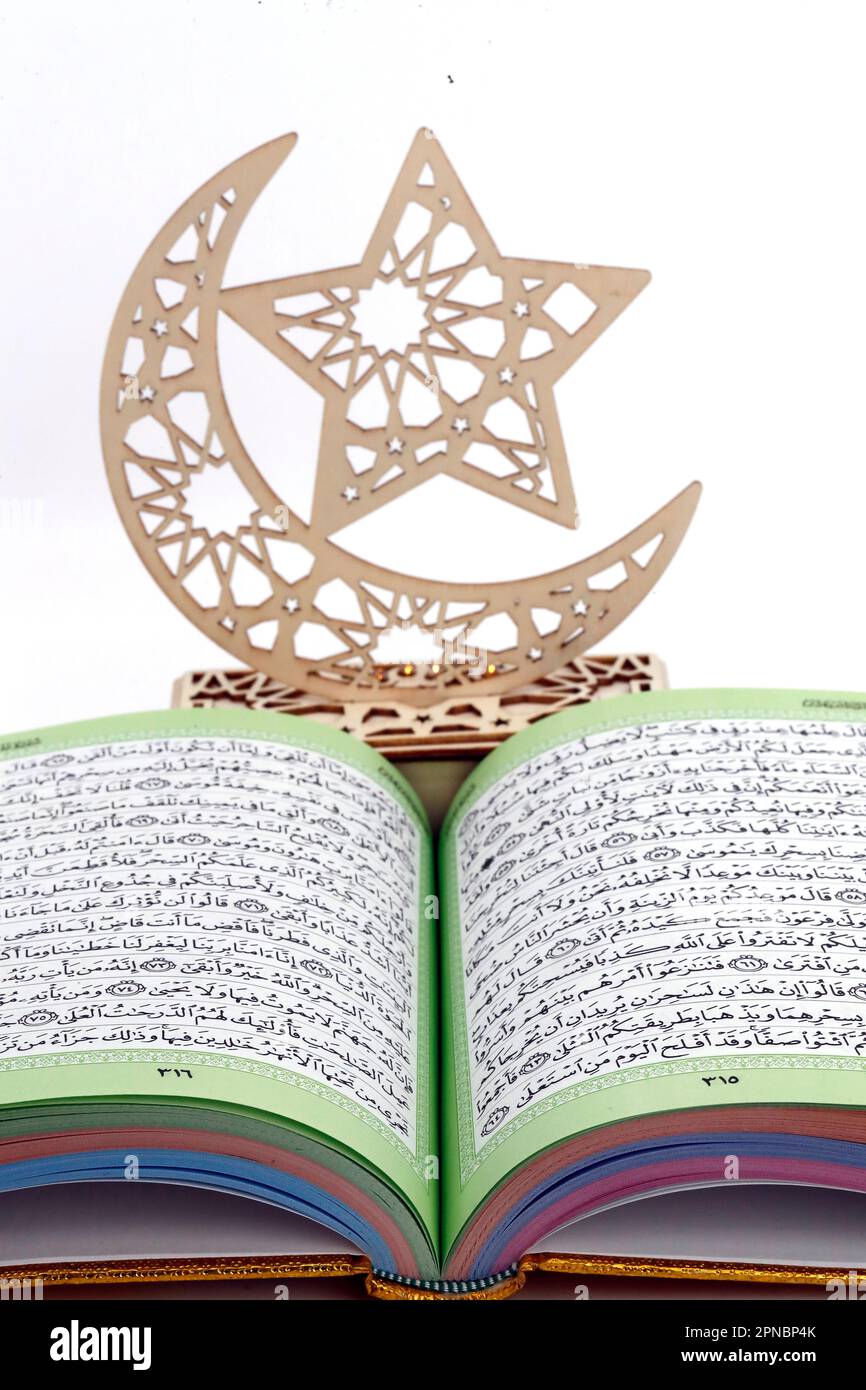 Open holy Quran ( Kuran ) and Crescent and Star, symbols of Islamic ...