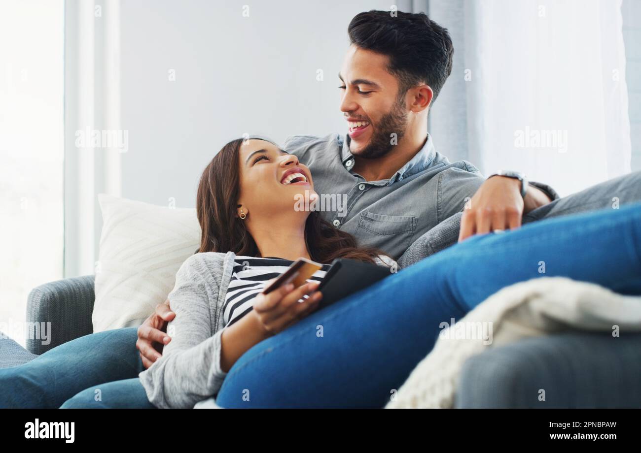 Woman lounging on sofa using hi-res stock photography and images - Alamy