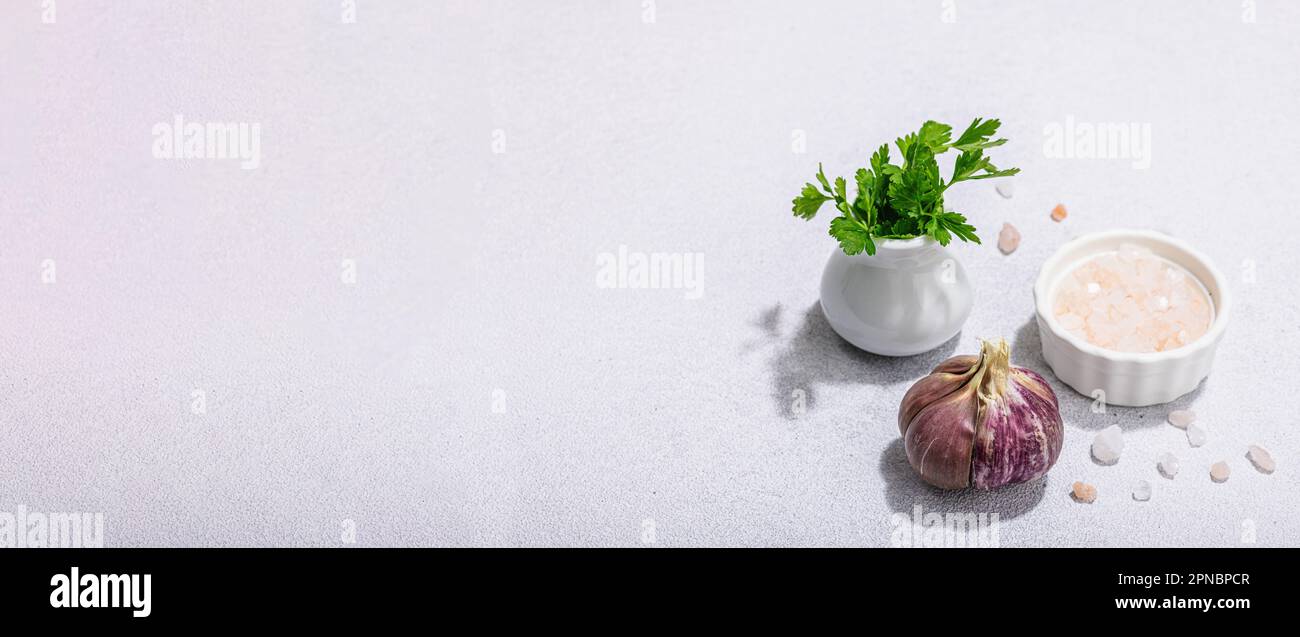 Kitchen cooking background with fresh parsley, garlic and sea salt ...