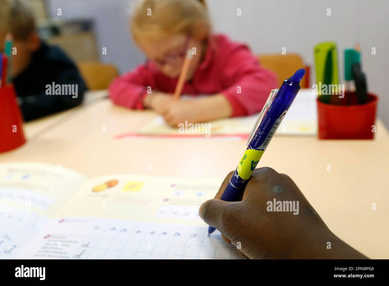Education. Classroom in a primary school. Pupils writing. Saint-Gervais ...