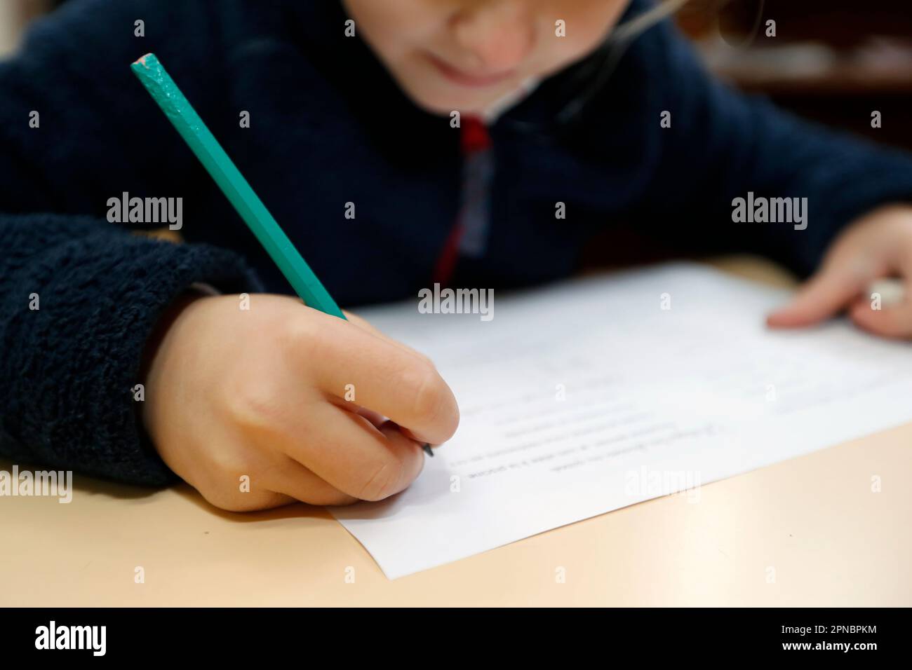 Education. Classroom in a primary school. Pupil writing. Saint-Gervais ...