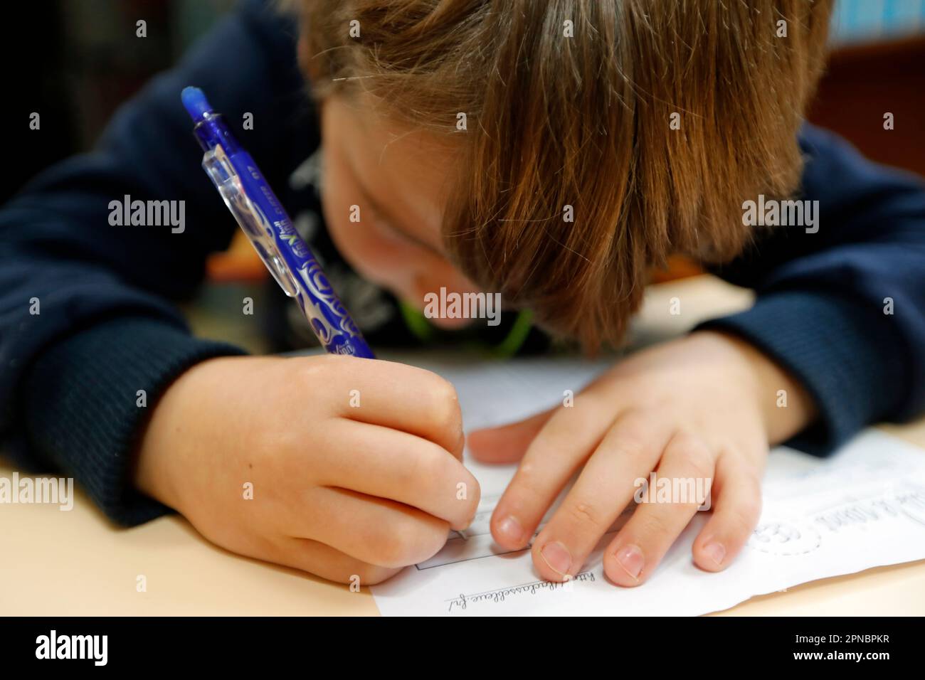 Education. Classroom in a primary school. Pupil writing. Saint-Gervais ...