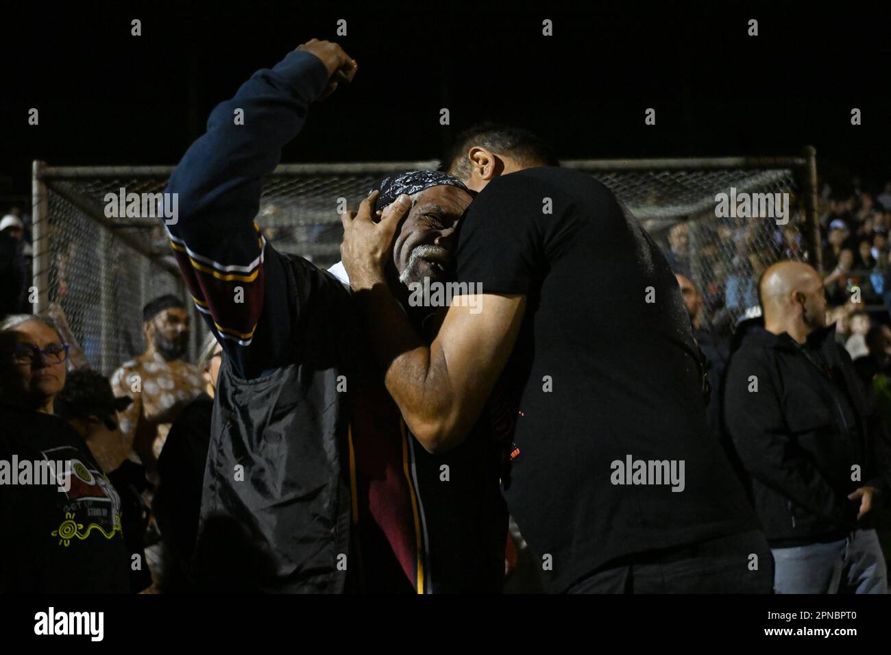 A man embraces former AFL footballer Nicky Winmar (right) during a ...