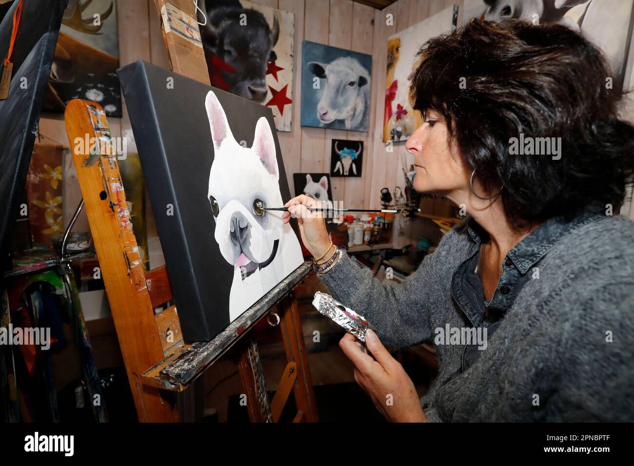 French artist Muriel Mollier Pierret painting in her gallery. Saint ...