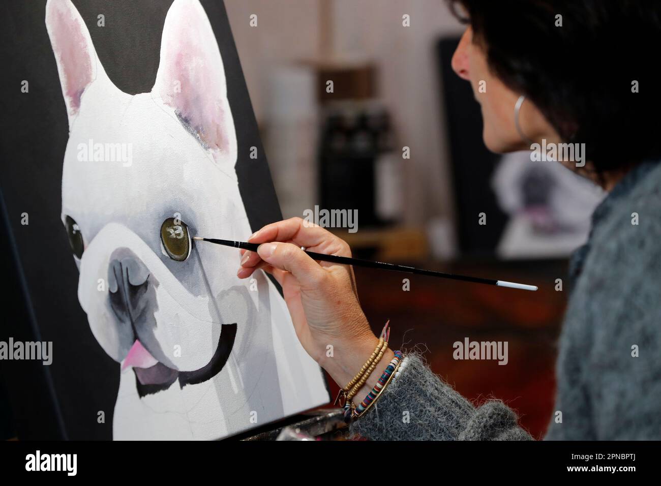 French artist Muriel Mollier Pierret painting in her gallery. Saint ...