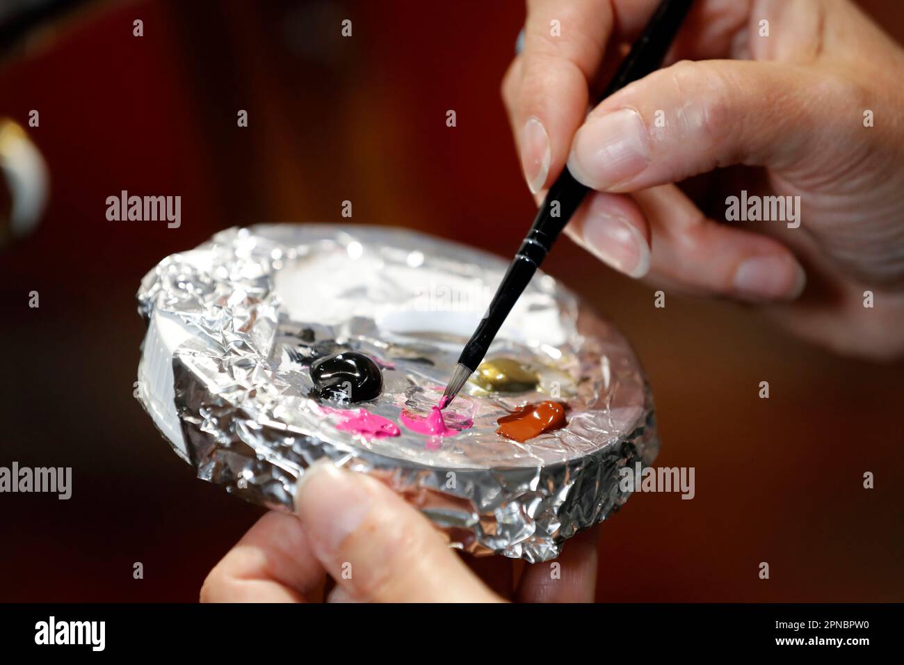 French artist Muriel Mollier Pierret painting in her gallery. Saint ...