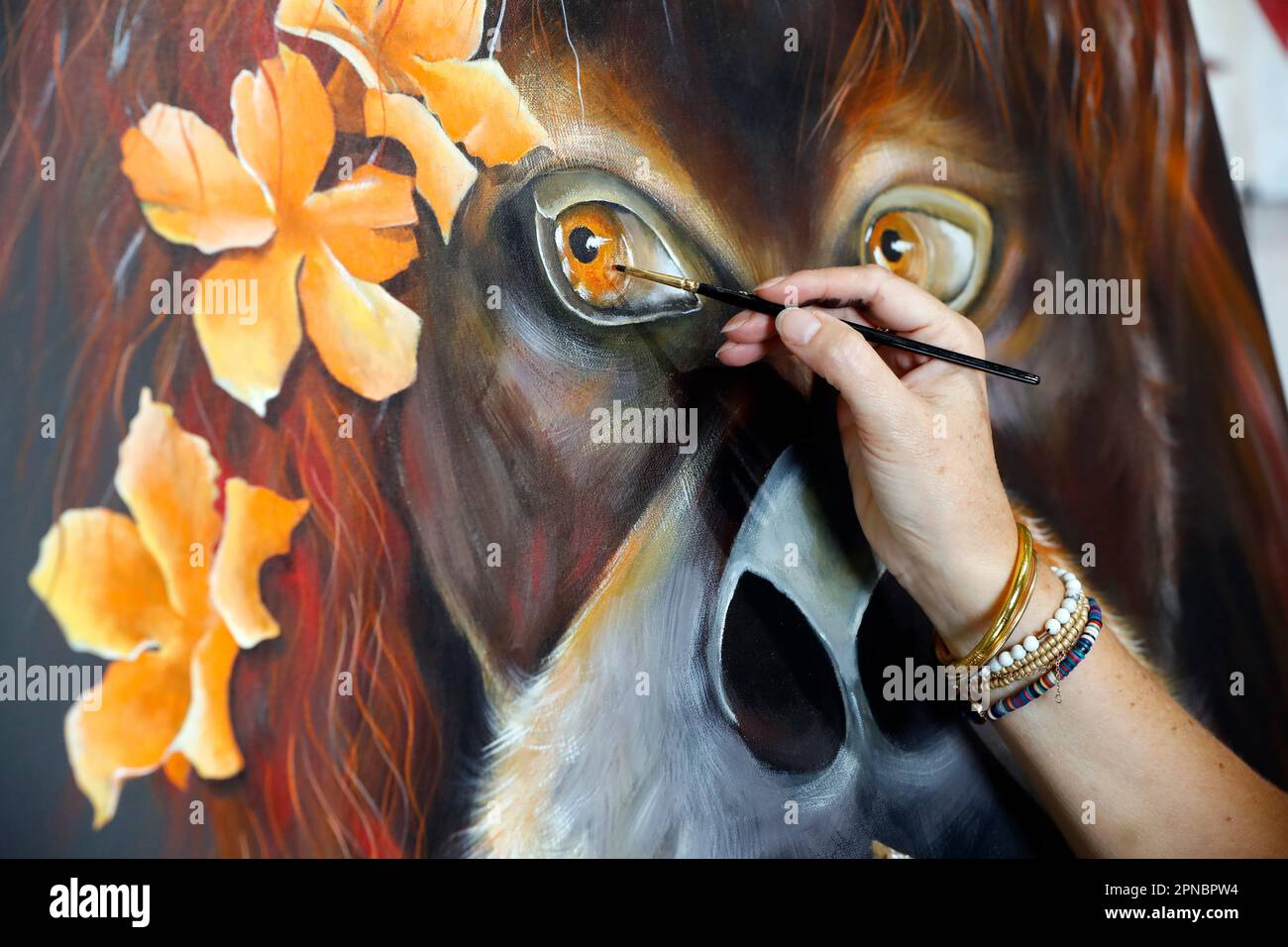 French artist Muriel Mollier Pierret painting in her gallery. Saint ...