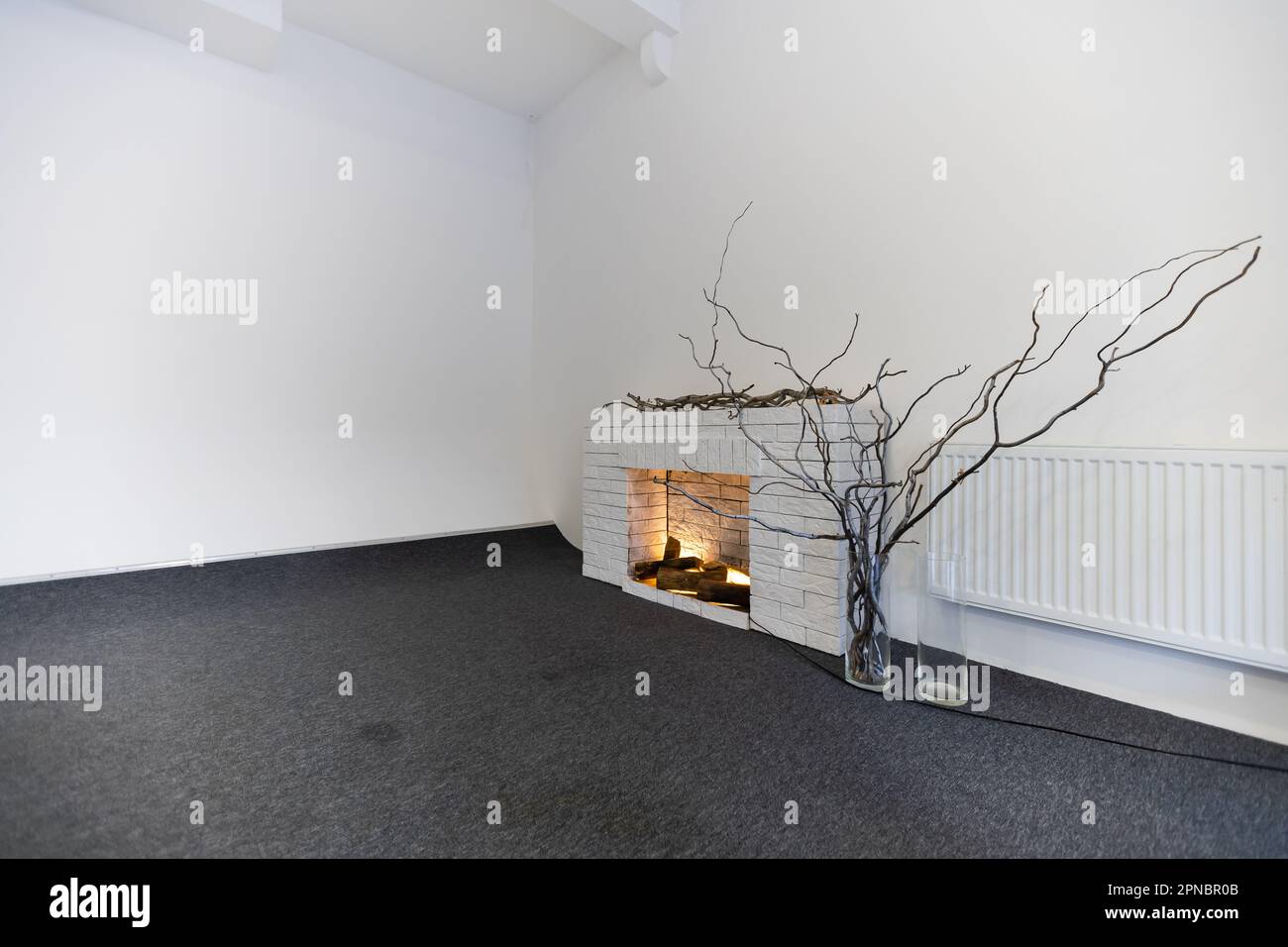 Decorative fake fireplace in room Stock Photo - Alamy