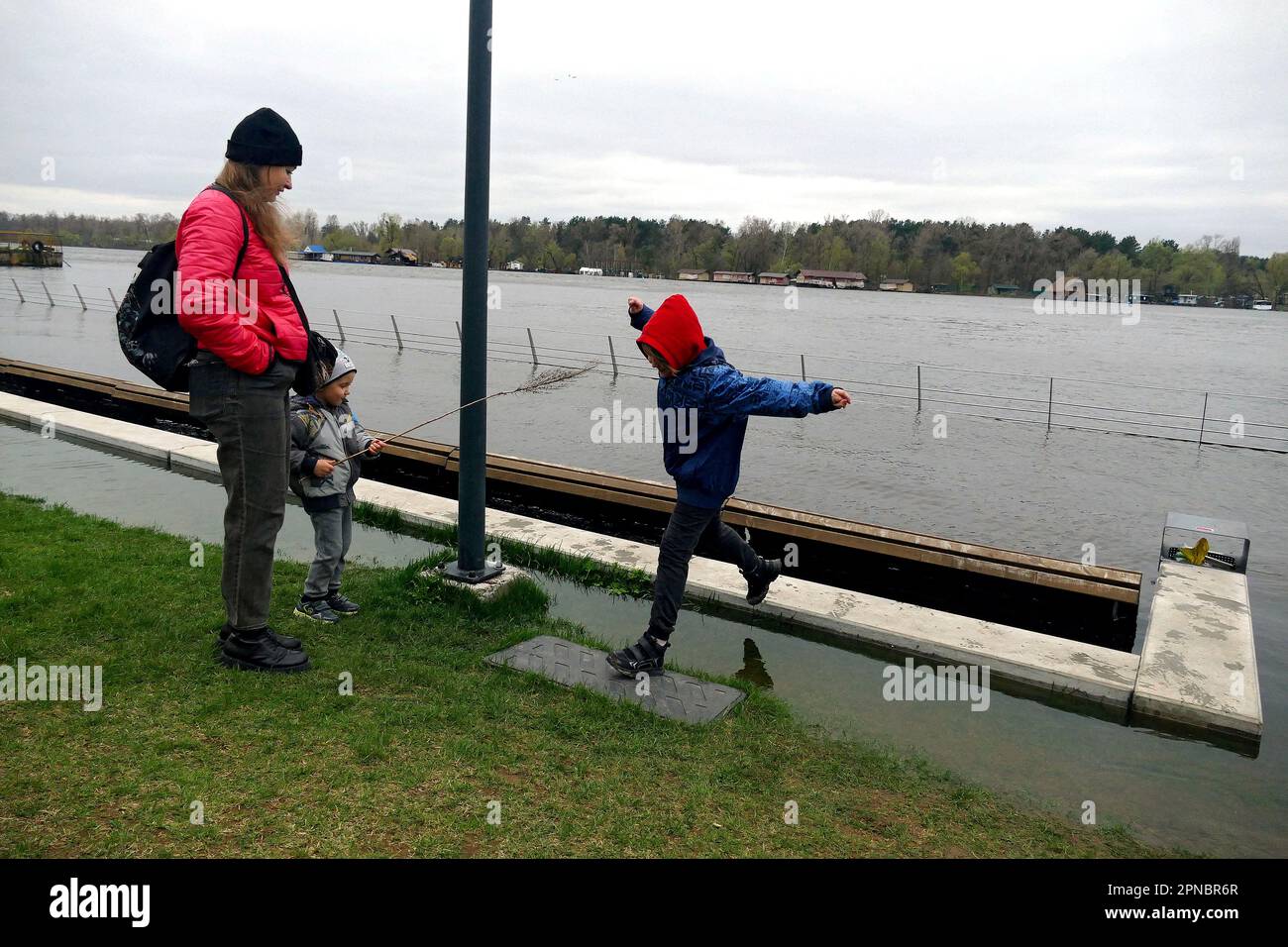 KYIV, UKRAINE - APRIL 15, 2023 - A woman and children stay by the ...