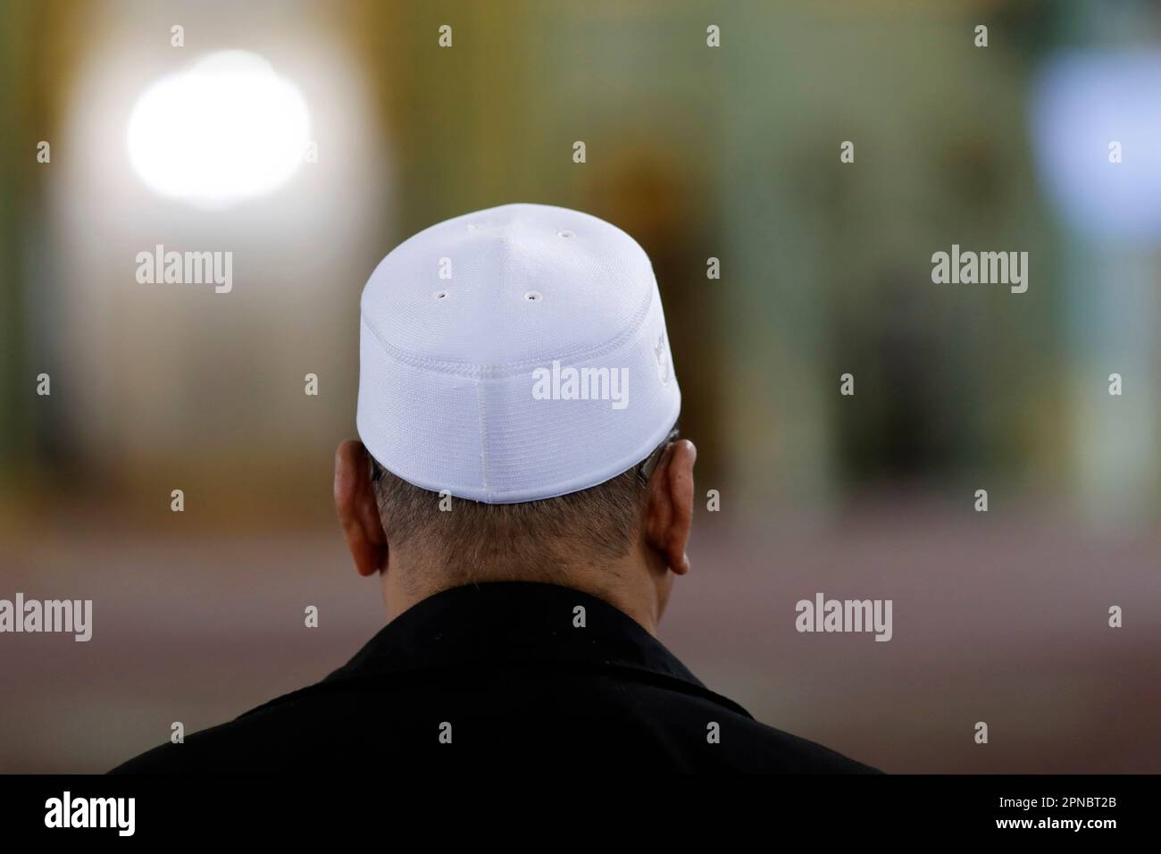 The Sultan Mosque, or Masjid Sultan. Back view of a muslim man praying ...