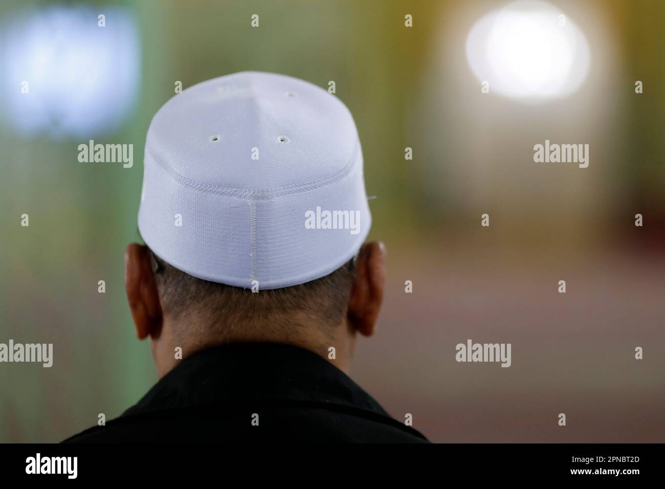 The Sultan Mosque, or Masjid Sultan. Back view of a muslim man praying ...