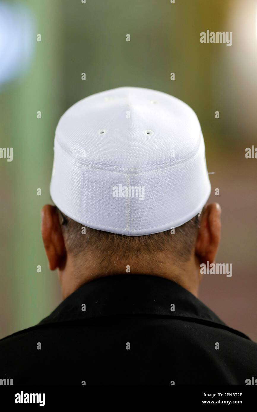 The Sultan Mosque, or Masjid Sultan. Back view of a muslim man praying ...