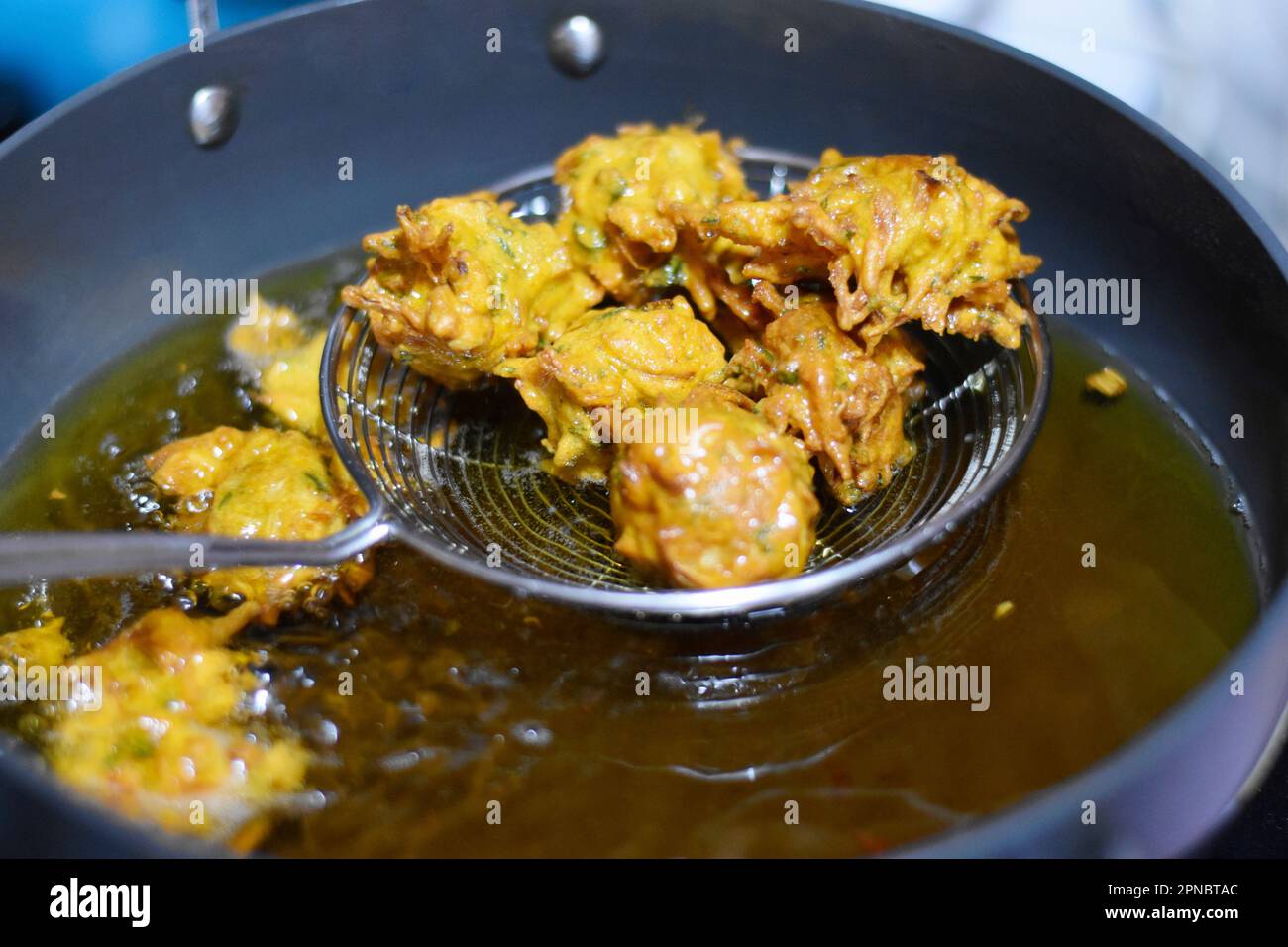 Image of deep Frying onion pakoras or pyaj pakoda also known as crispy ...