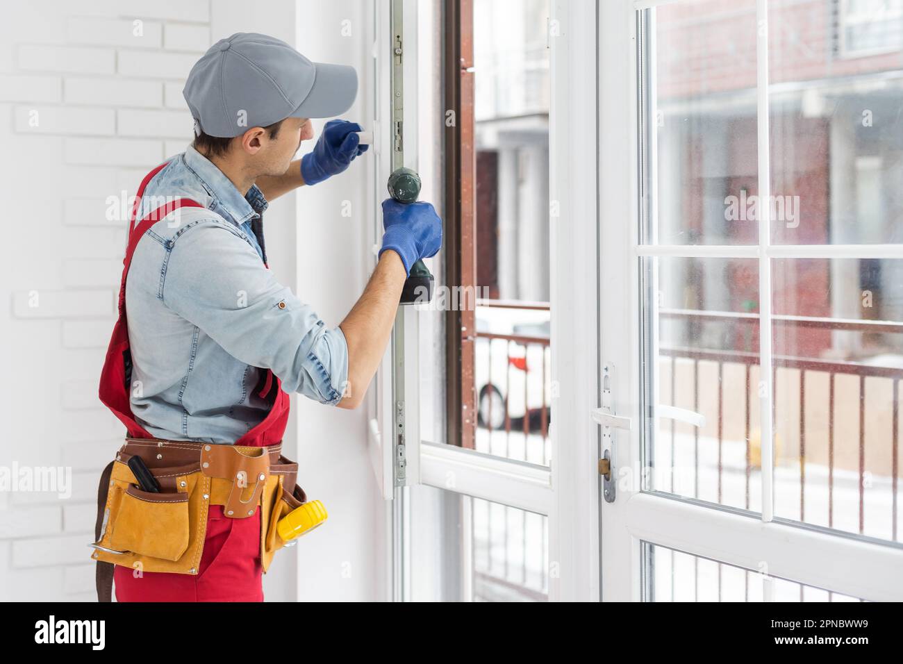 Construction worker installing window in house. Handyman fixing the ...