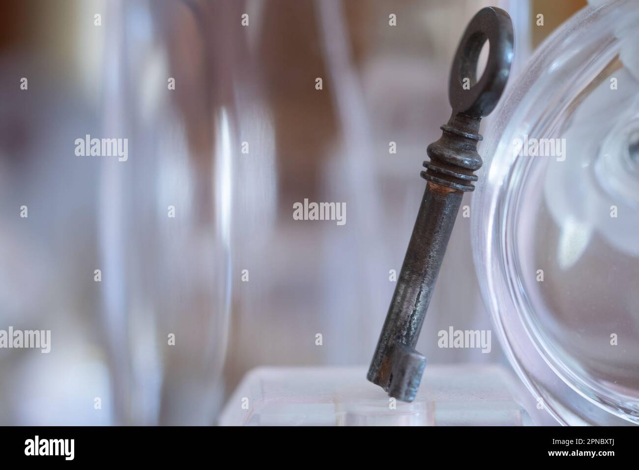 old brass key placed in the middle of perfume bottle Stock Photo - Alamy