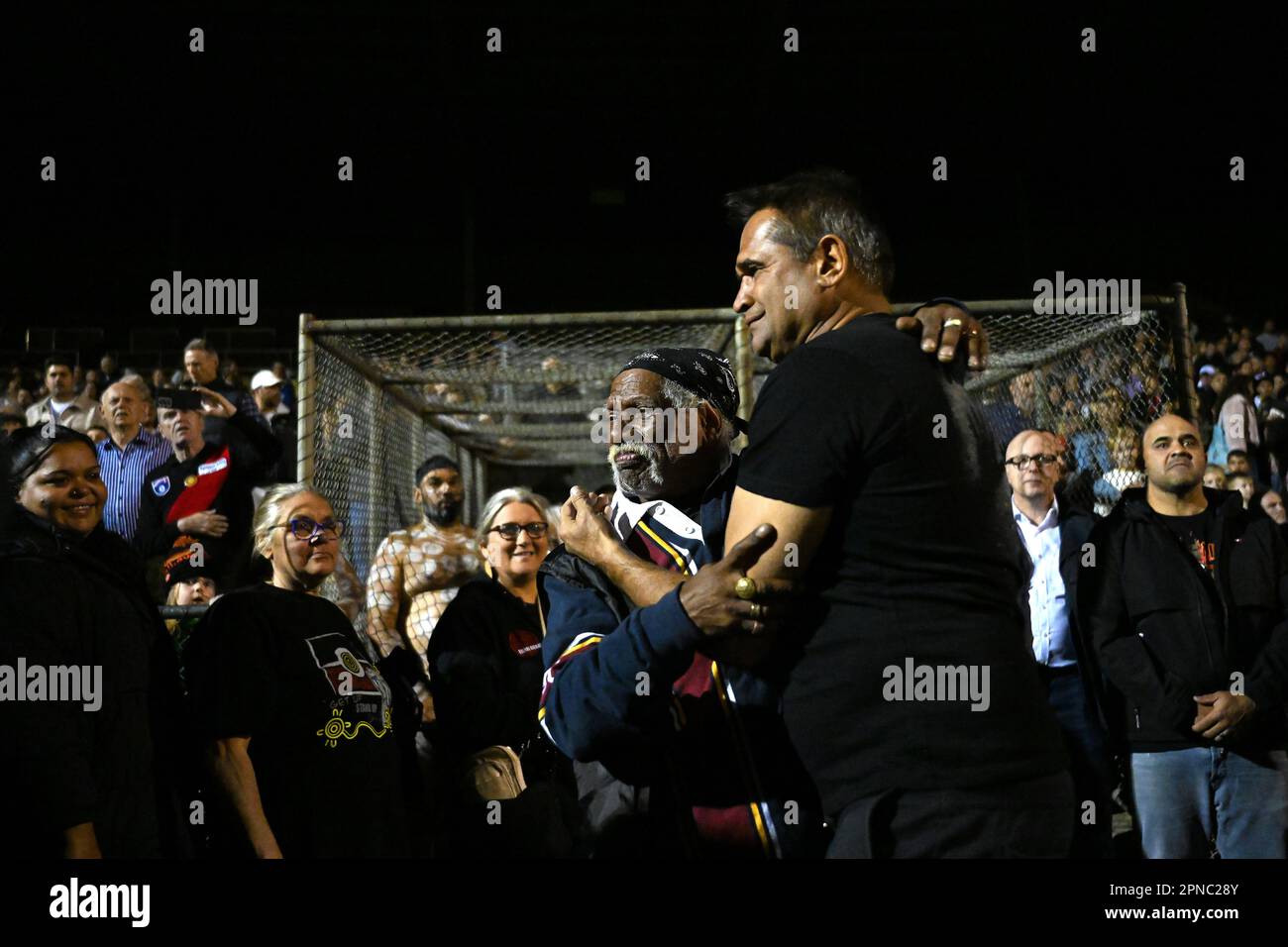 A man embraces former AFL footballer Nicky Winmar (right) during a ...