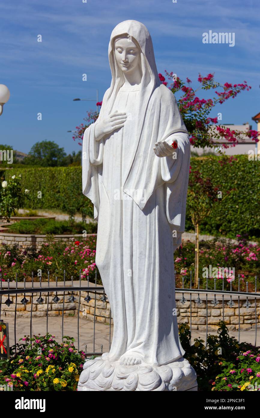 The statue of the Queen of Peace near the St James Church in Medjugorje ...